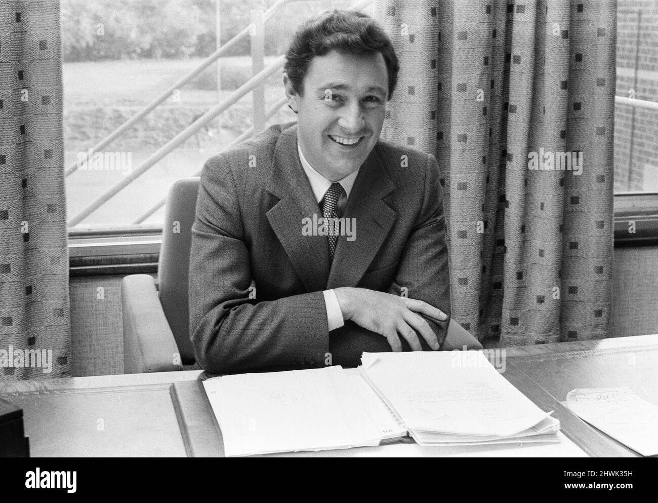Geoffrey Robinson, Managing Director Jaguar Cars, pictured at his desk ...