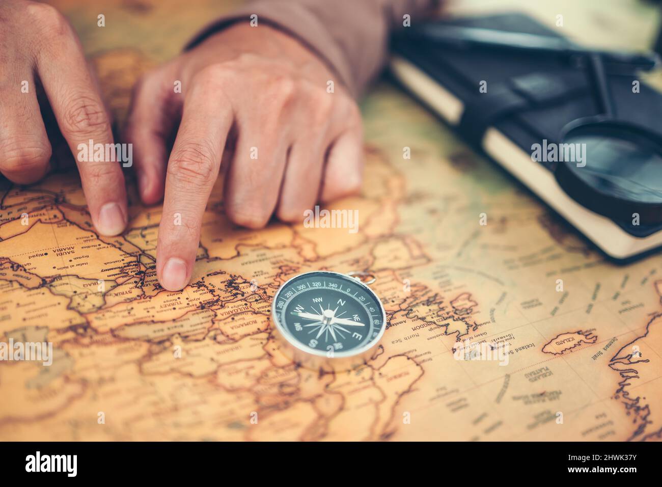 Tourist planning vacation, holiday with the help world map and compass ...