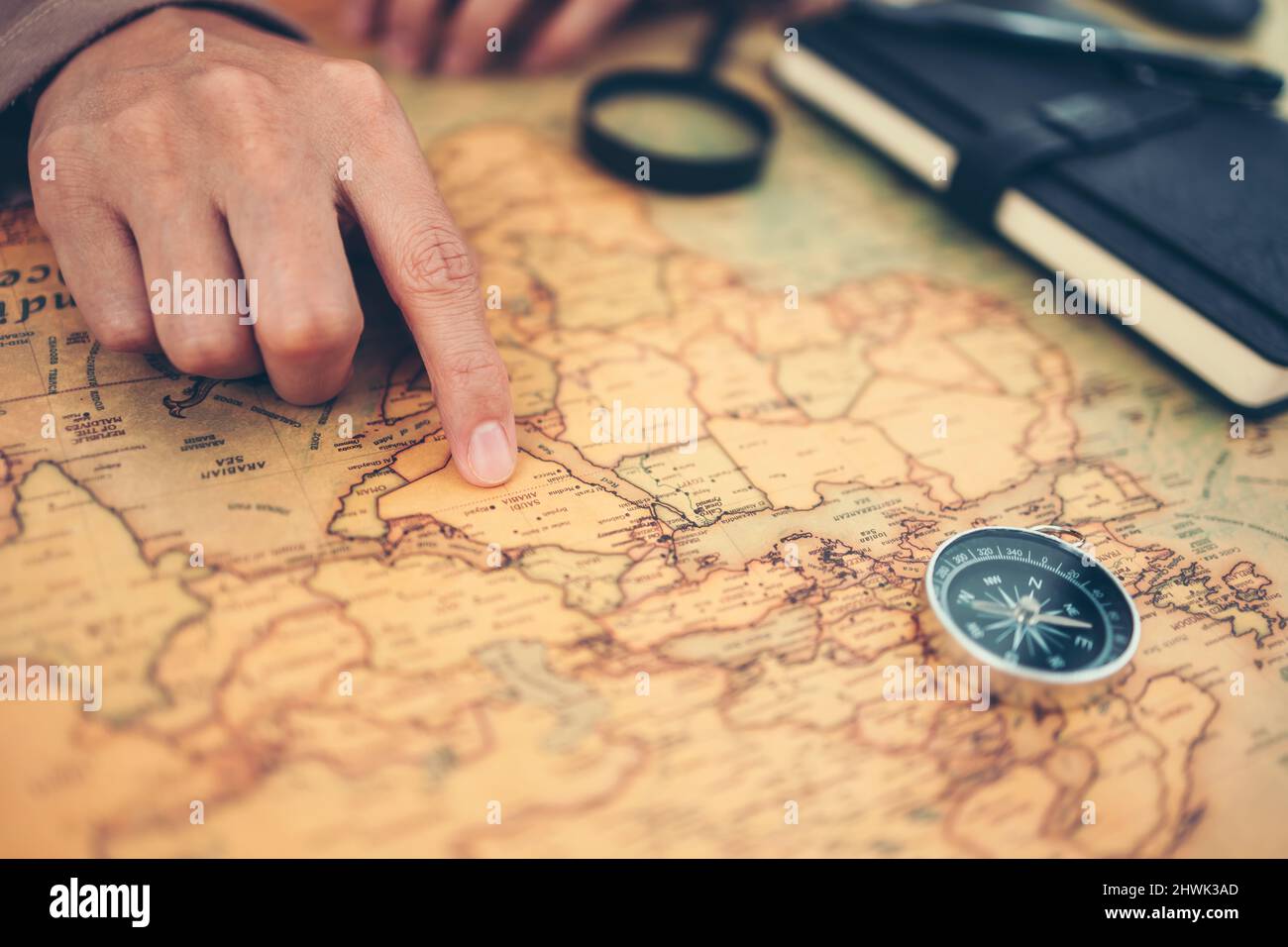 Tourist planning vacation, holiday with the help world map and compass ...