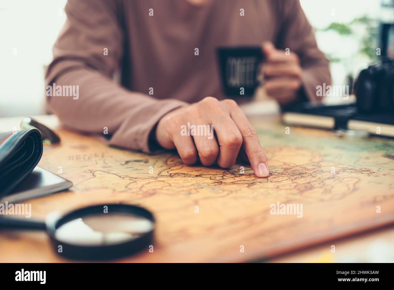 Tourist planning vacation, holiday with the help world map. Man's hand ...