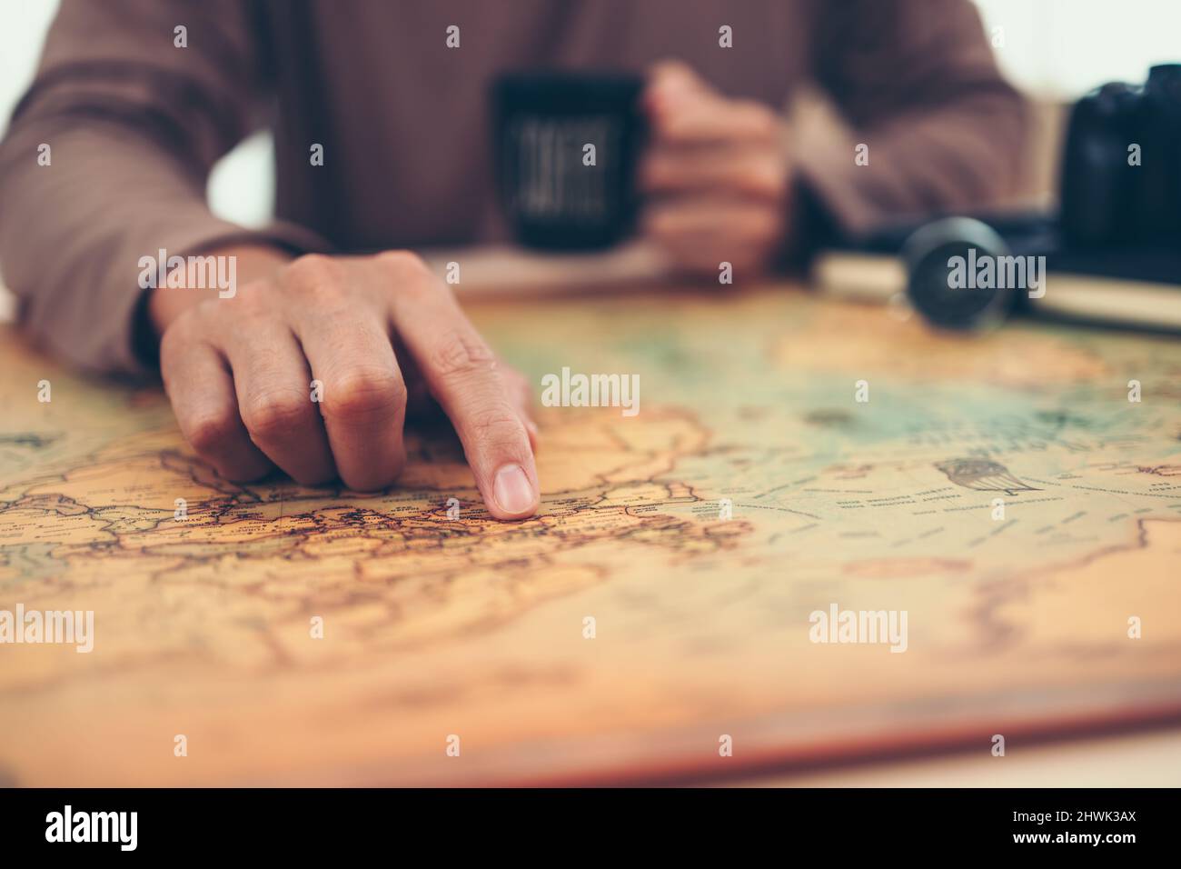 Tourist planning vacation, holiday with the help world map. Man's hand ...