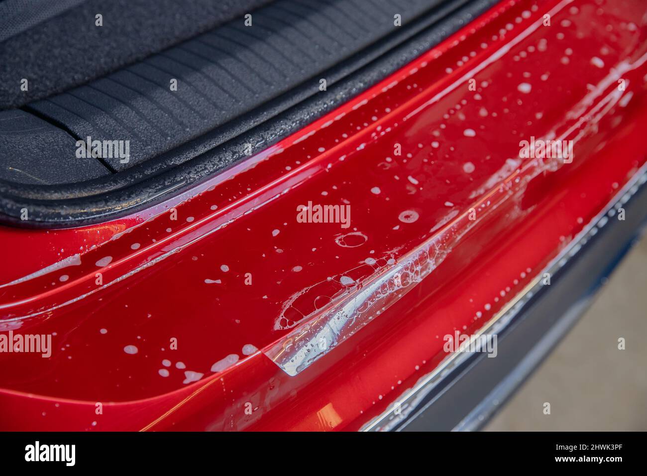 Master man installs vinyl film protect trunk loading area car body ...