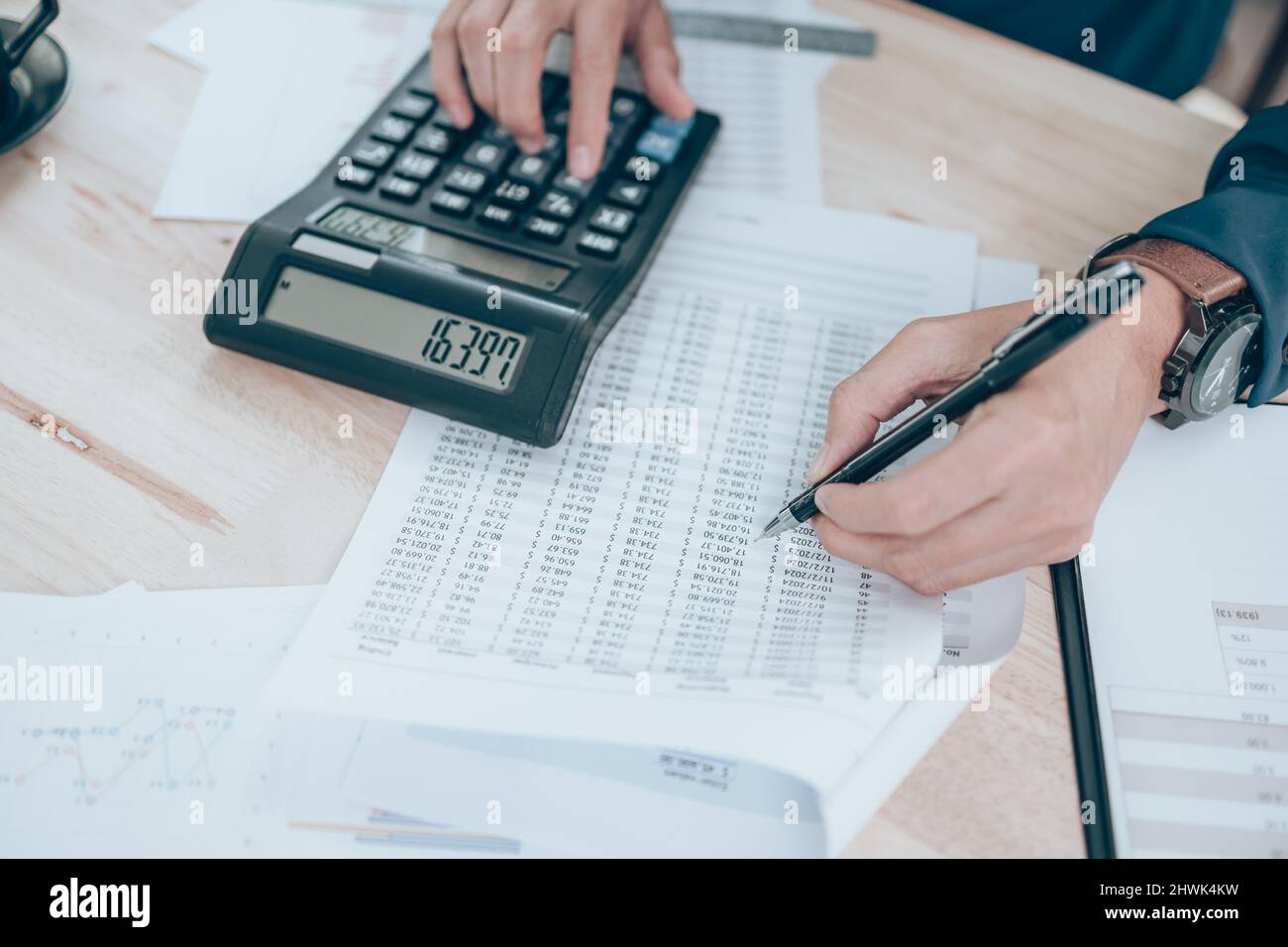 Accountant writing, checking and working on company data, document ...