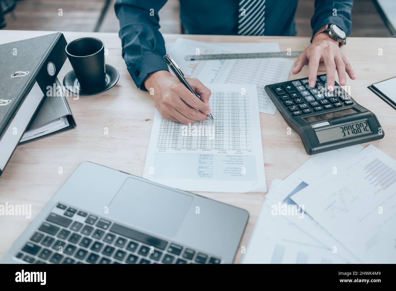 Accountant writing, checking and working on company data, document ...