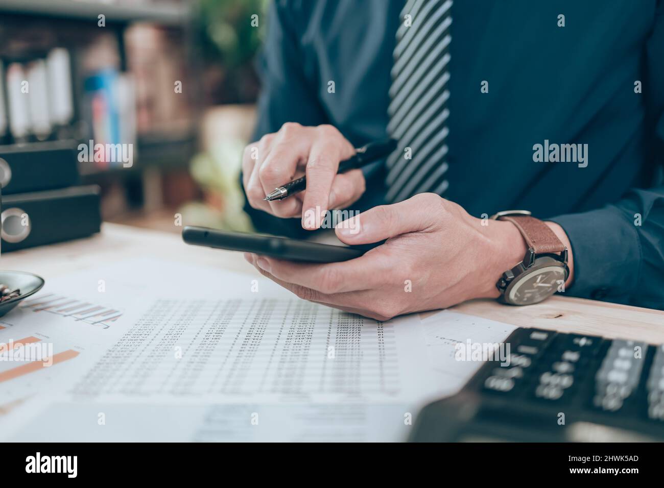 Businessman use cell phone and working on office desk and analyzing new ...