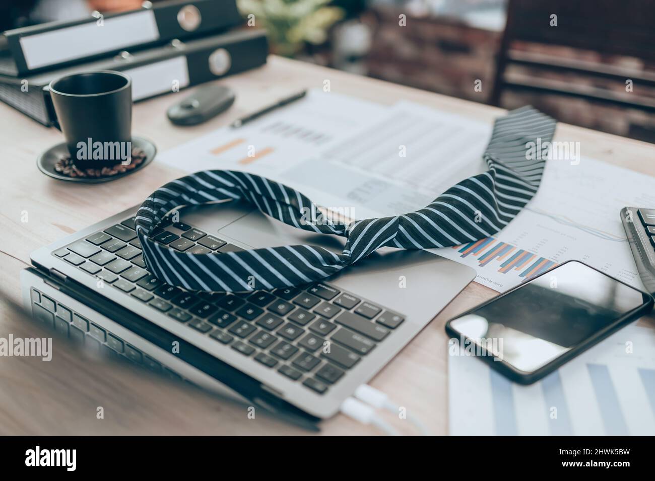Accountant necktie on laptop while working on laptop to calculate ...