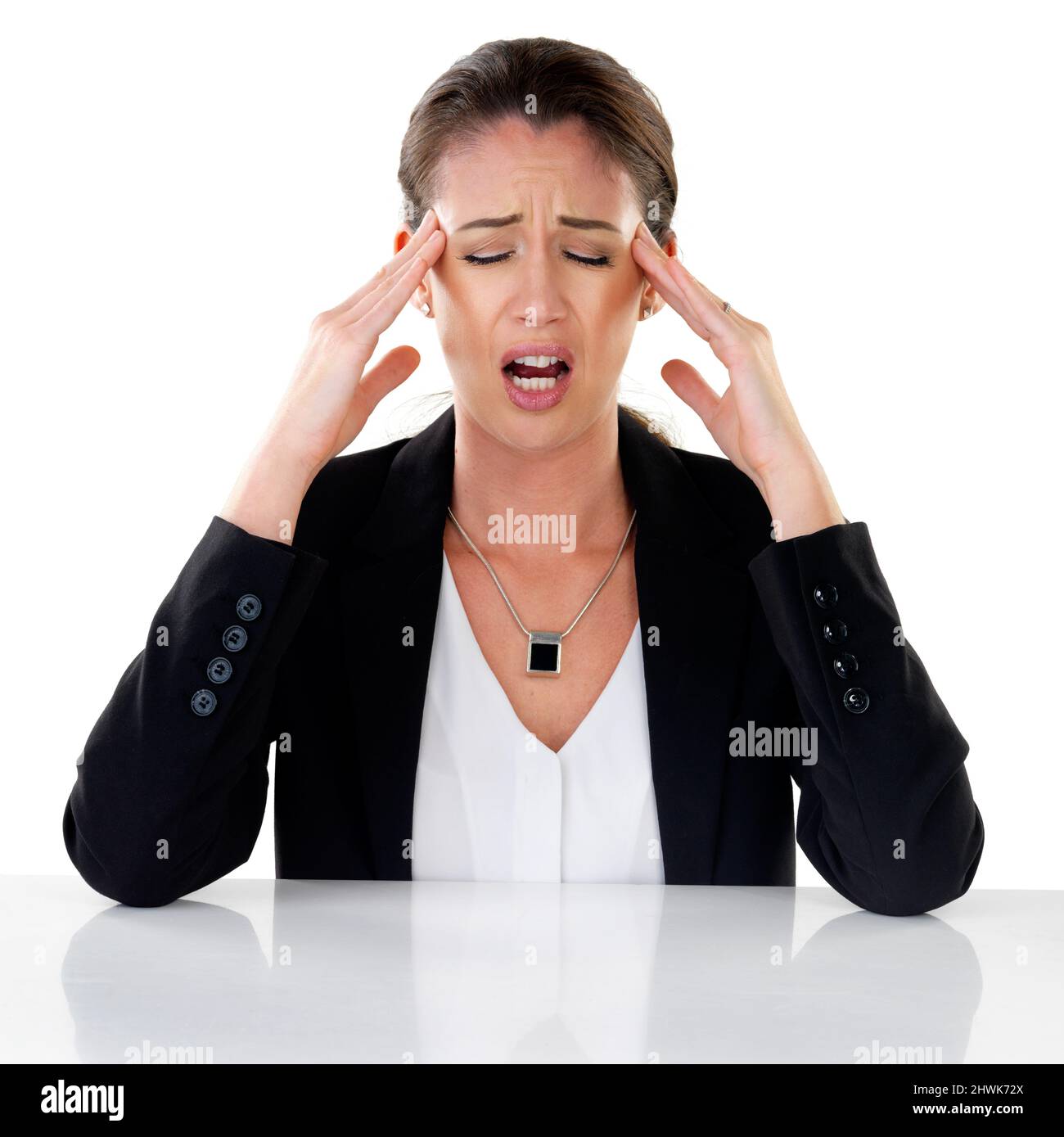 Headaches, what a pain. Studio shot of a young businesswoman ...