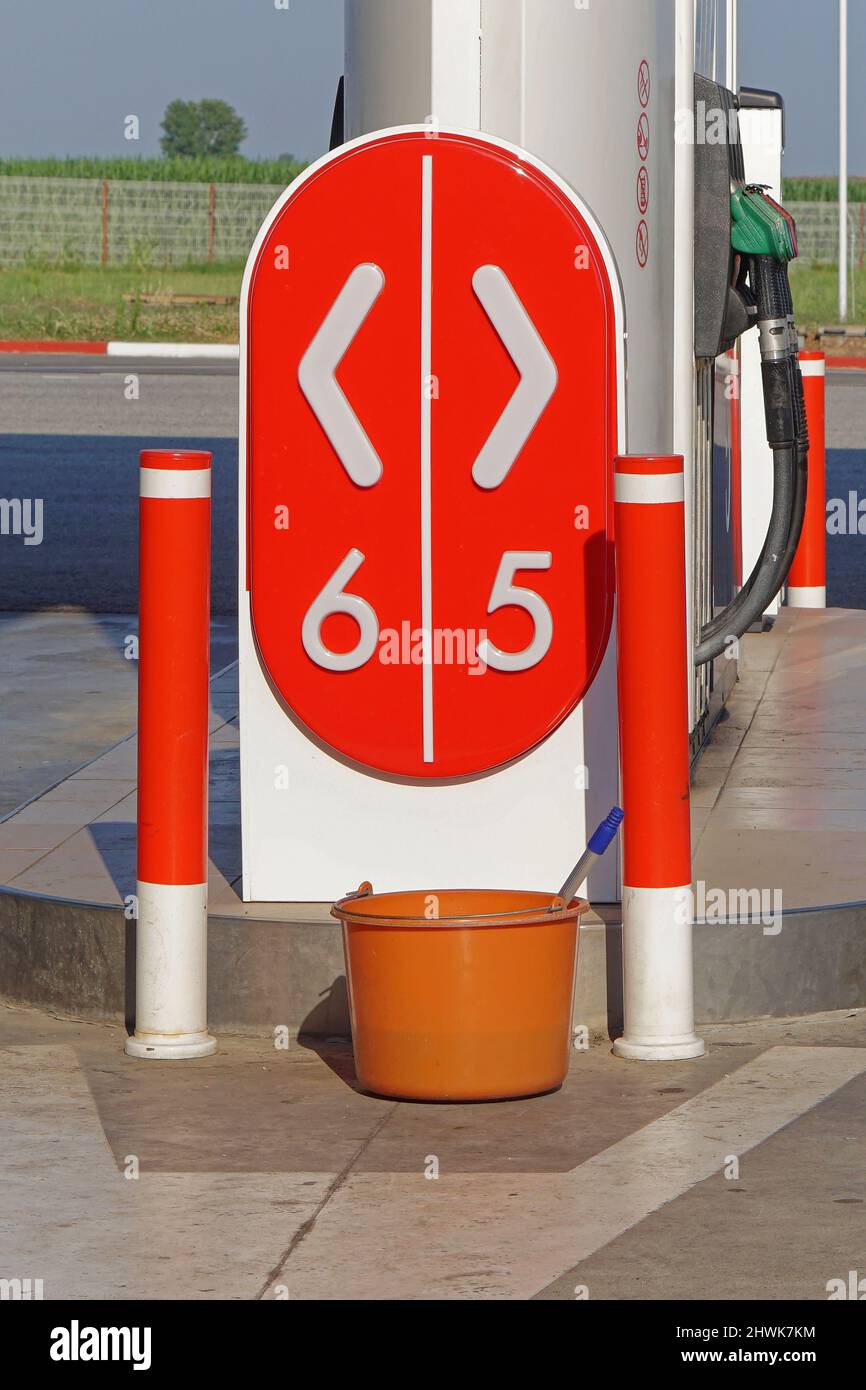 Petrol station arrows numbers red sign and water bucket Stock Photo - Alamy