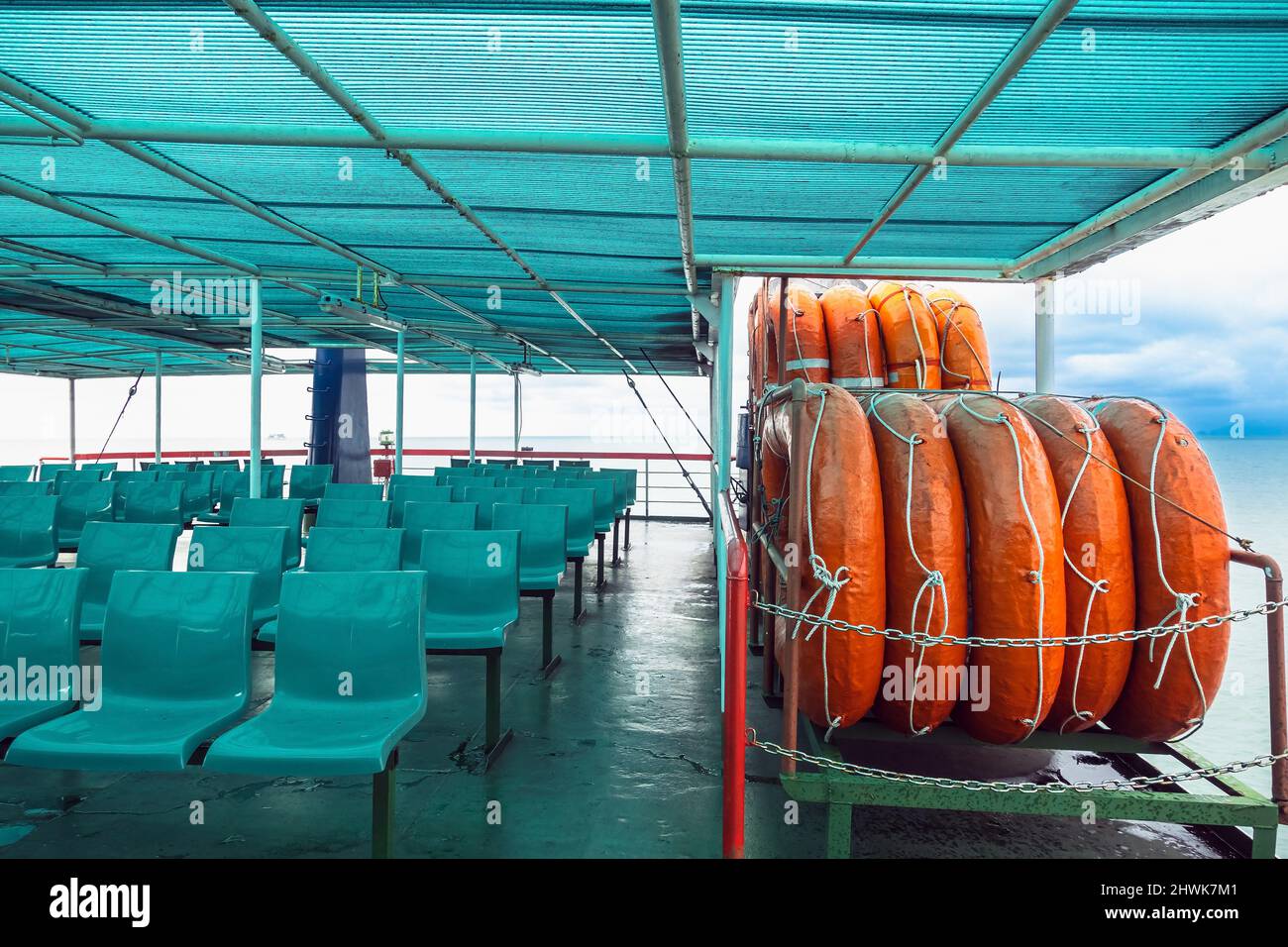 Orange inflatable lifeboats on ferry deck for emergencies and maritime ...