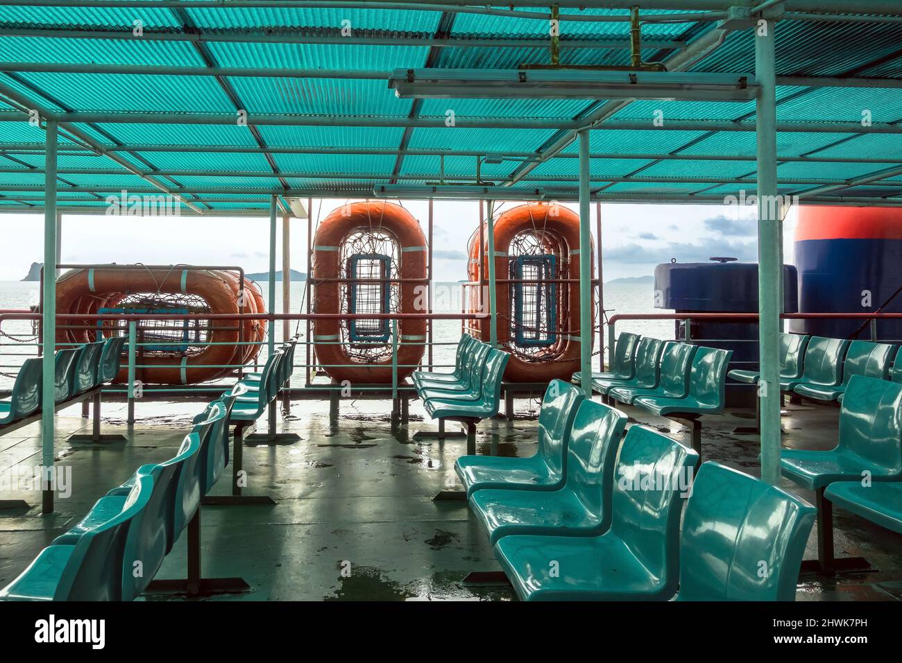 Orange inflatable lifeboats on ferry deck for emergencies and maritime ...