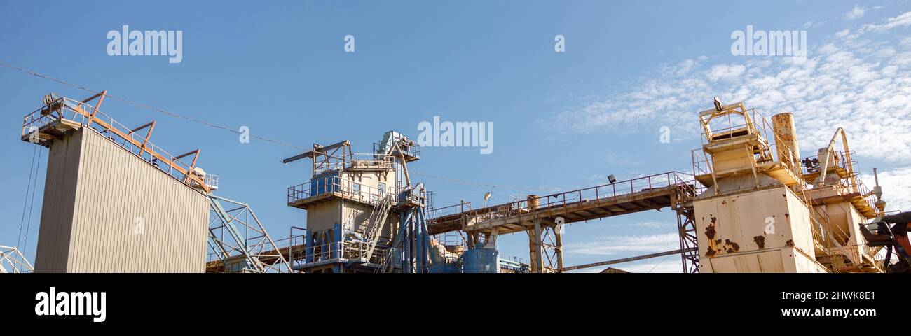 Blue sky over factory with buildings and machinery Stock Photo - Alamy