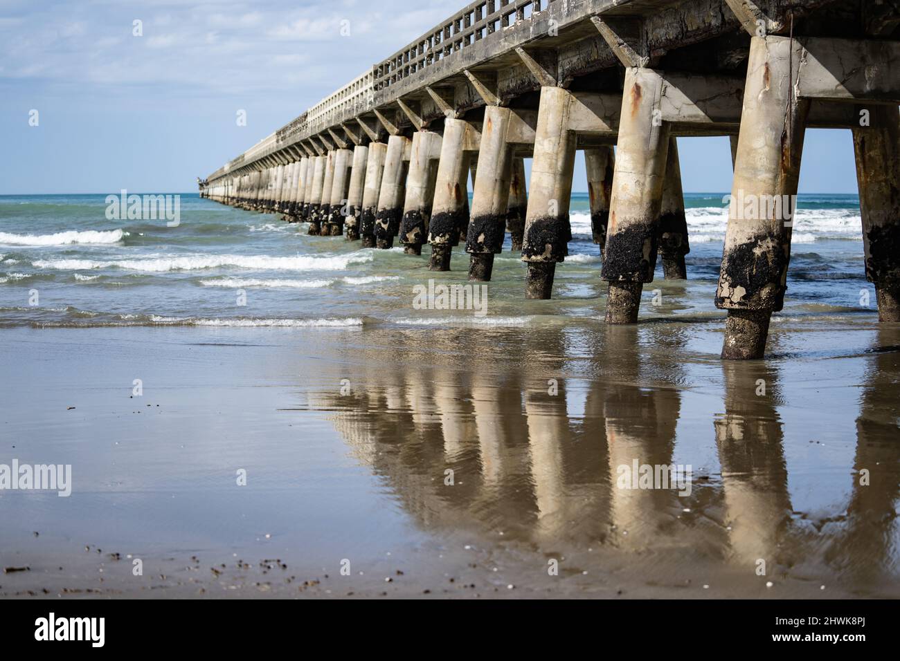 Long repeating structural pattern,reflection in wet sand and ...
