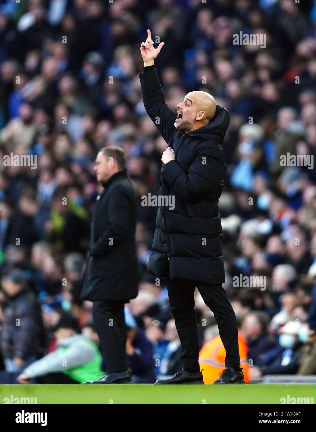 Manchester City manager Pep Guardiola (right) gestures on the touchline ...
