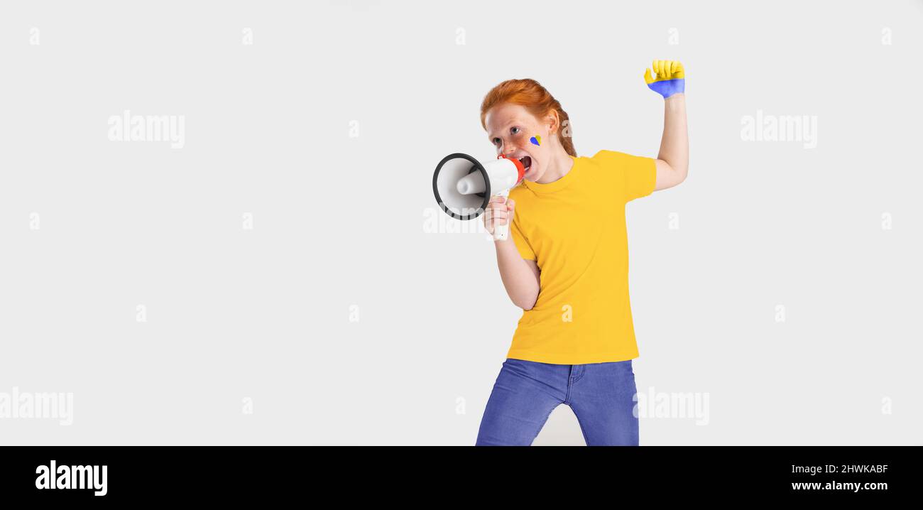 Conceptual portrait with little girl, kid shouting at megaphone ...