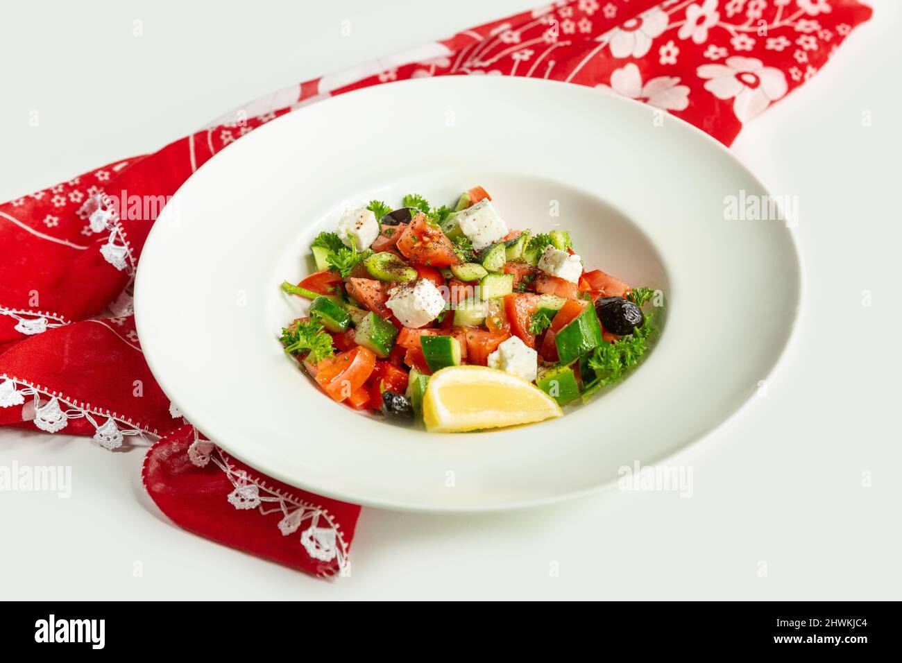 Turkish fresh Coban salad in a dish isolated on colorful table cloth ...