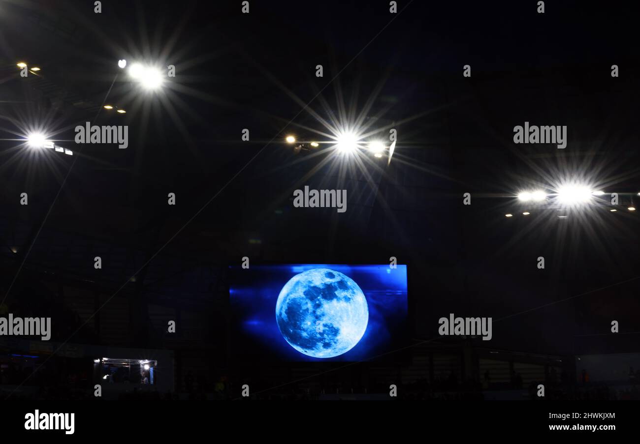 Manchester, UK. 6th Mar, 2022. The giant screen shows the Blue Moon ...
