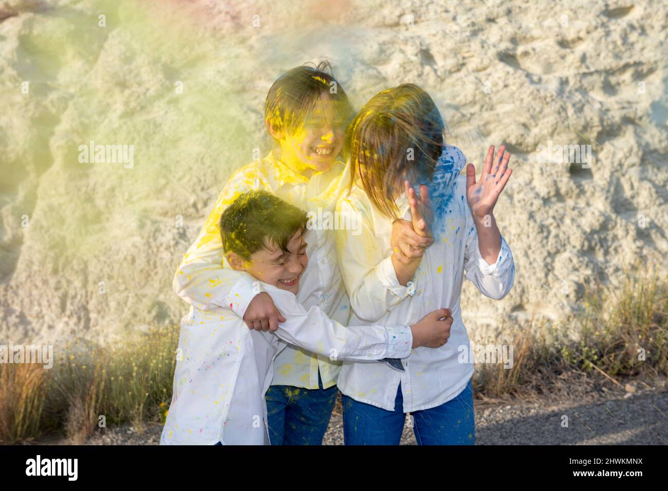Children friends and brothers playing with colored powder, friendship ...