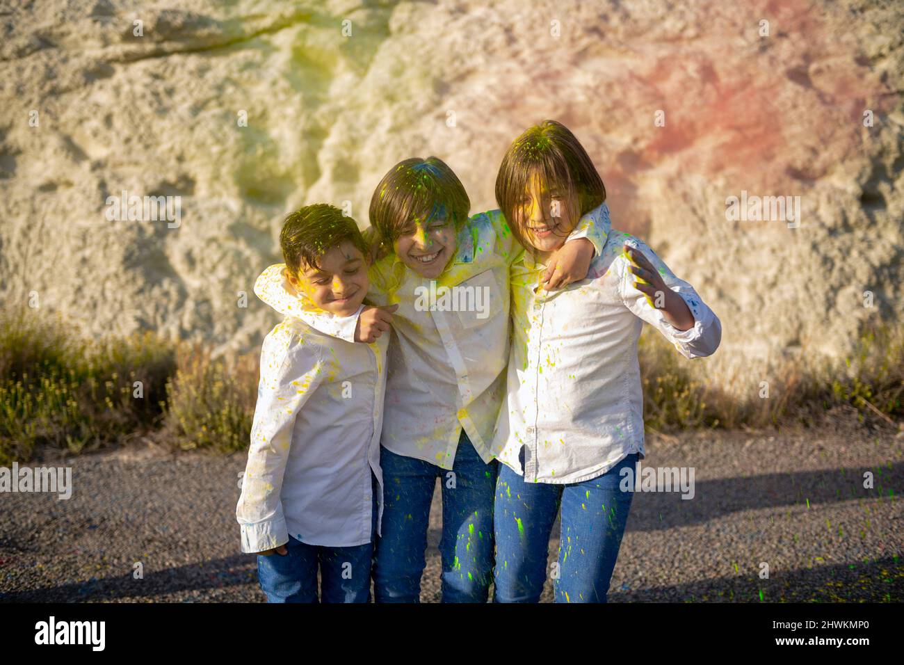 Children friends and brothers playing with colored powder, friendship ...