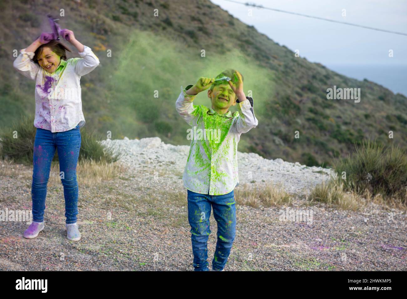 Children friends and brothers playing with colored powder, friendship ...