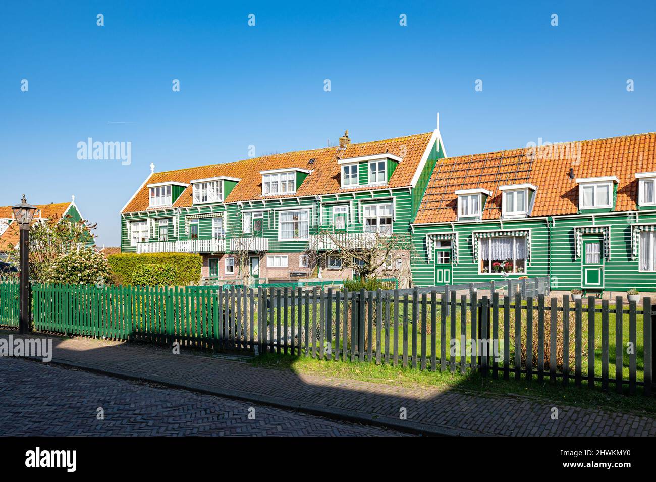 Scenic green painted wooden houses with orange colored roofs in the ...