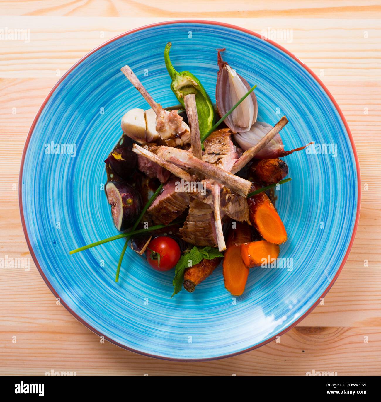 Top view of baked lamb ribs with vegetables, figs, demi-glace Stock ...