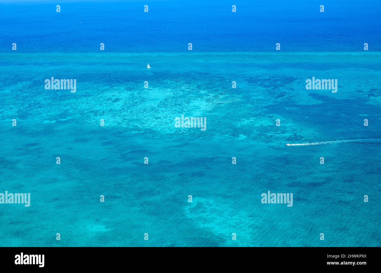 The Belize Barrier Reef against the deeper blue of the Caribbean Sea on ...