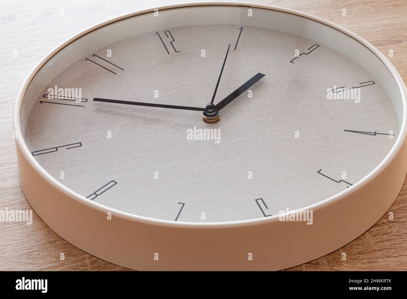 Close-up of a large round clock hand marking ten to two o'clock Stock ...