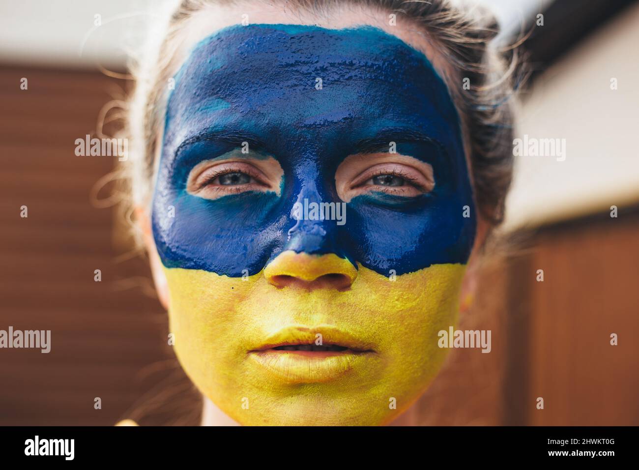 Outdoor portrait of young girl with blue and yellow ukrainian flag on ...