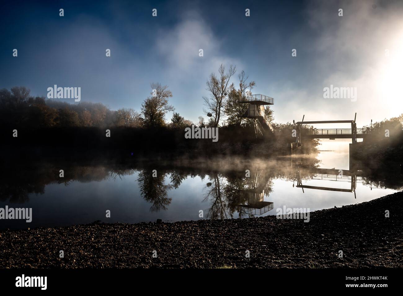 Bridge Over Light Covered Lake With The First Beams Of The Morning Sun ...