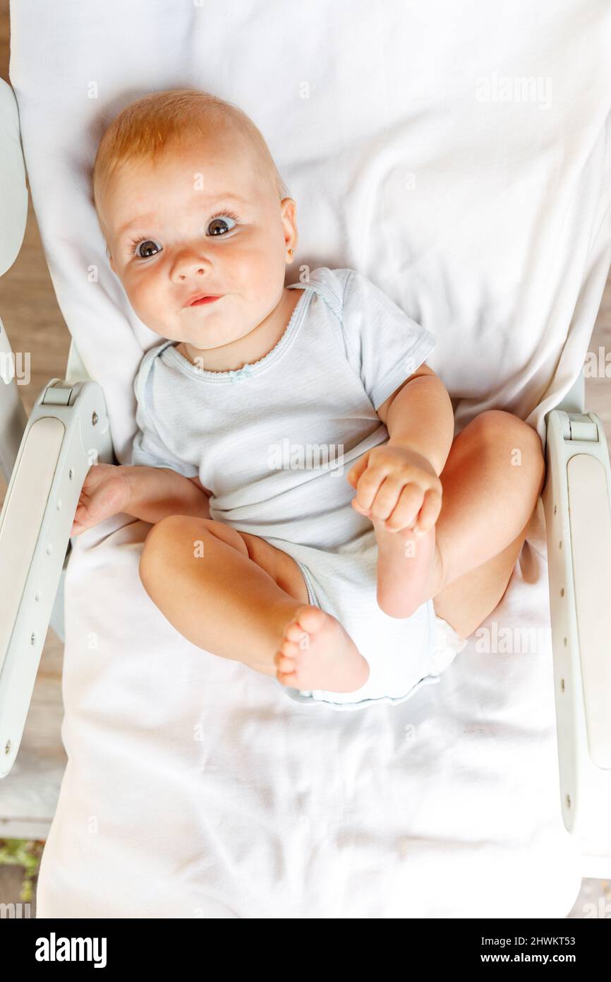Cute little newborn girl with smiling face looking at camera on white ...