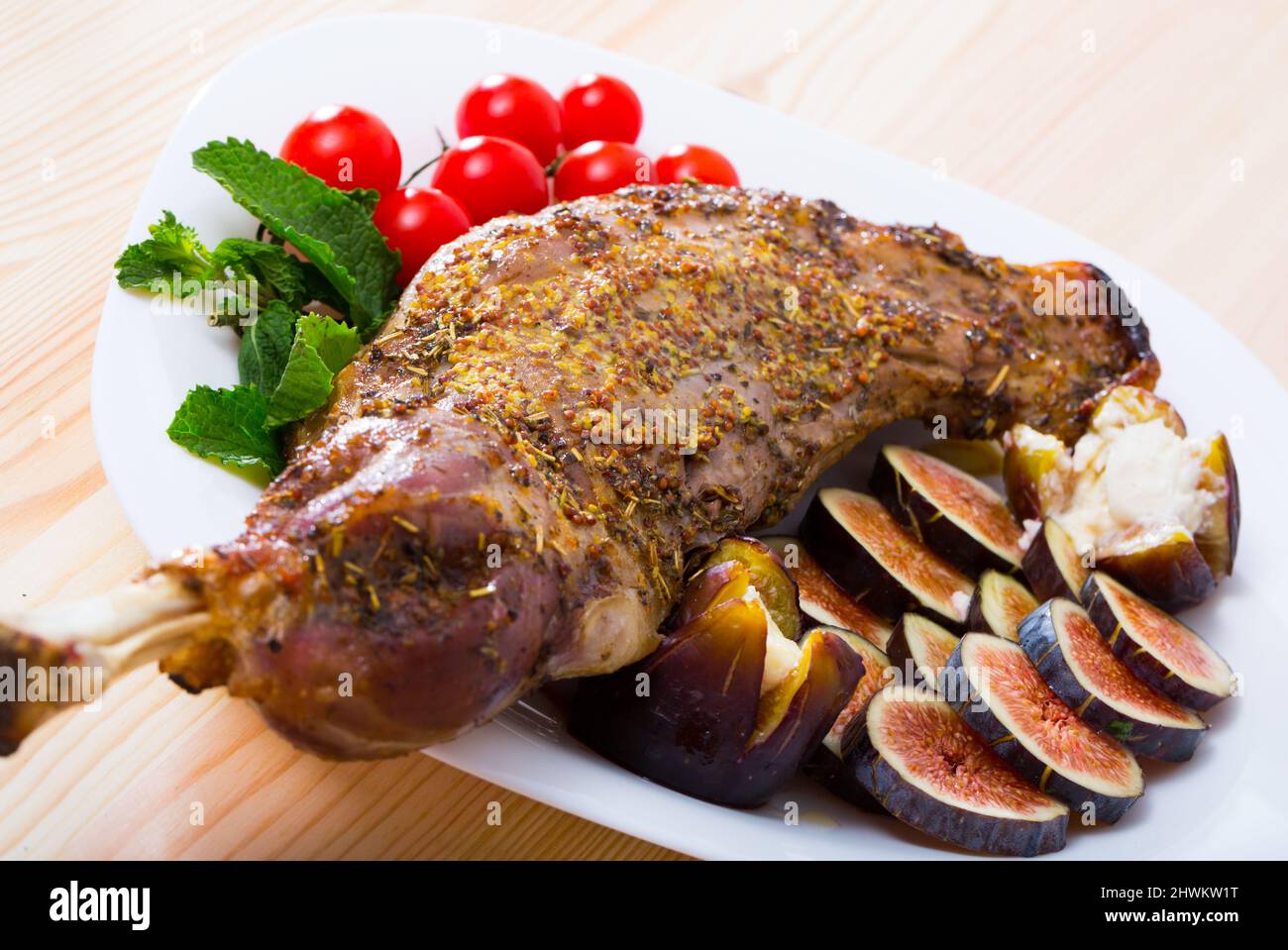 Baked shoulder of mutton with figs, tomatoes, soft cheese Stock Photo ...