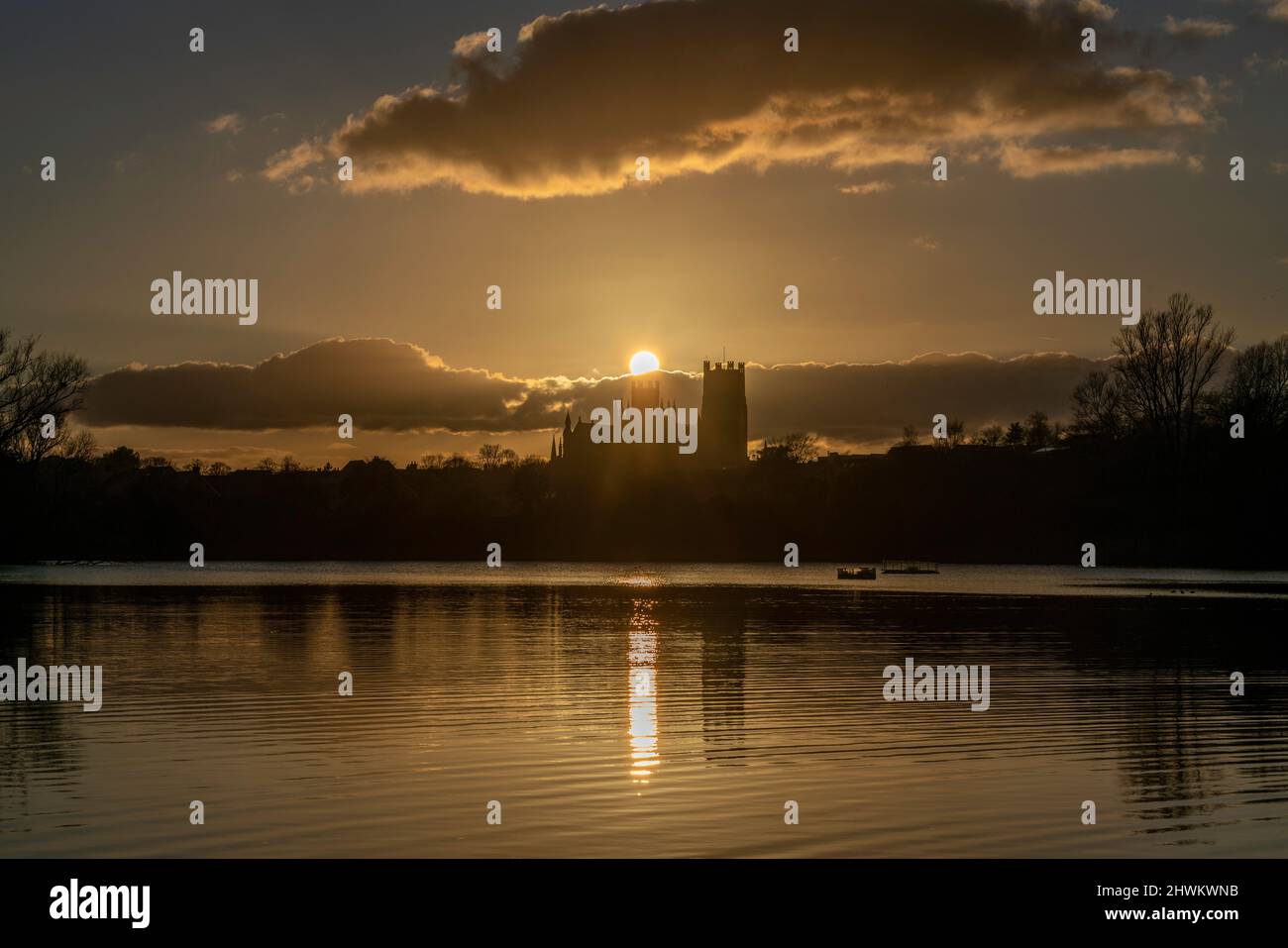 Sunset behind Ely Cathedral, as seen from Roswell Pits Nature reserve ...