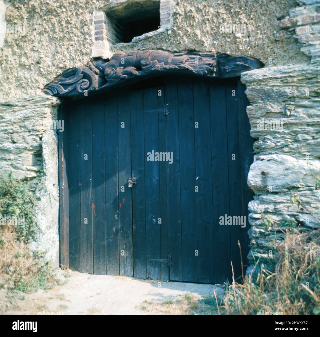 The old figurehead from a ship used as a lintel over a barn door in ...