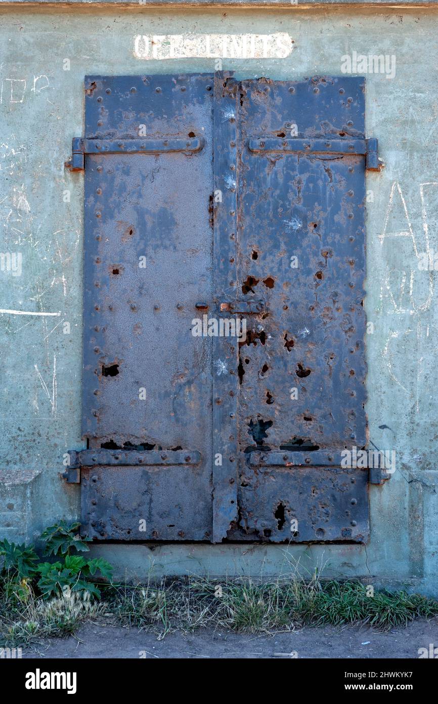 old black rusty metal door at concrete wall Stock Photo - Alamy