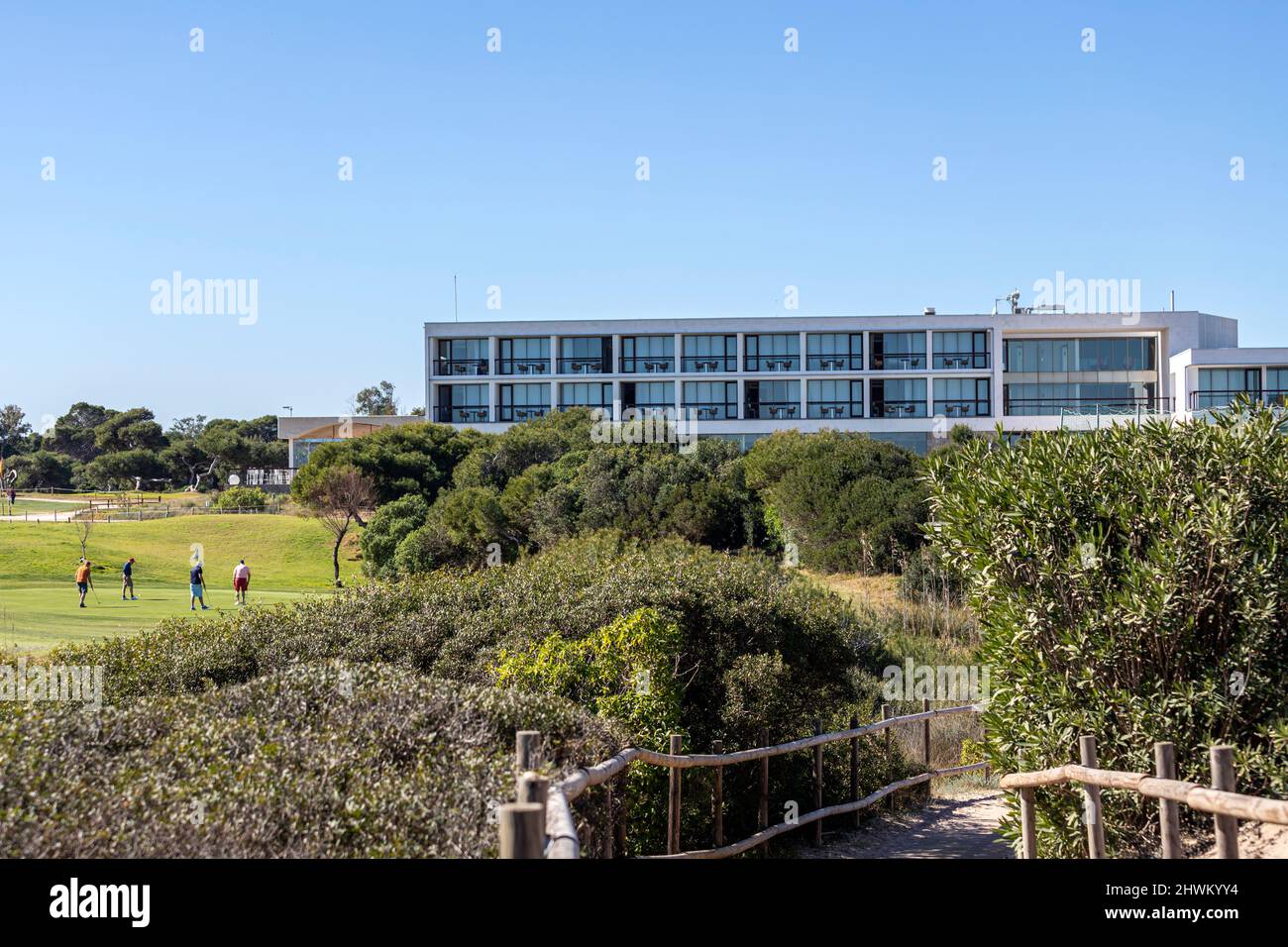 Golfers play golf in a Golf course near Parador Nacional de El Saler ...