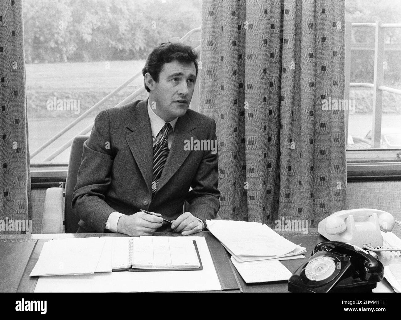 Geoffrey Robinson, Managing Director Jaguar Cars, pictured at his desk ...