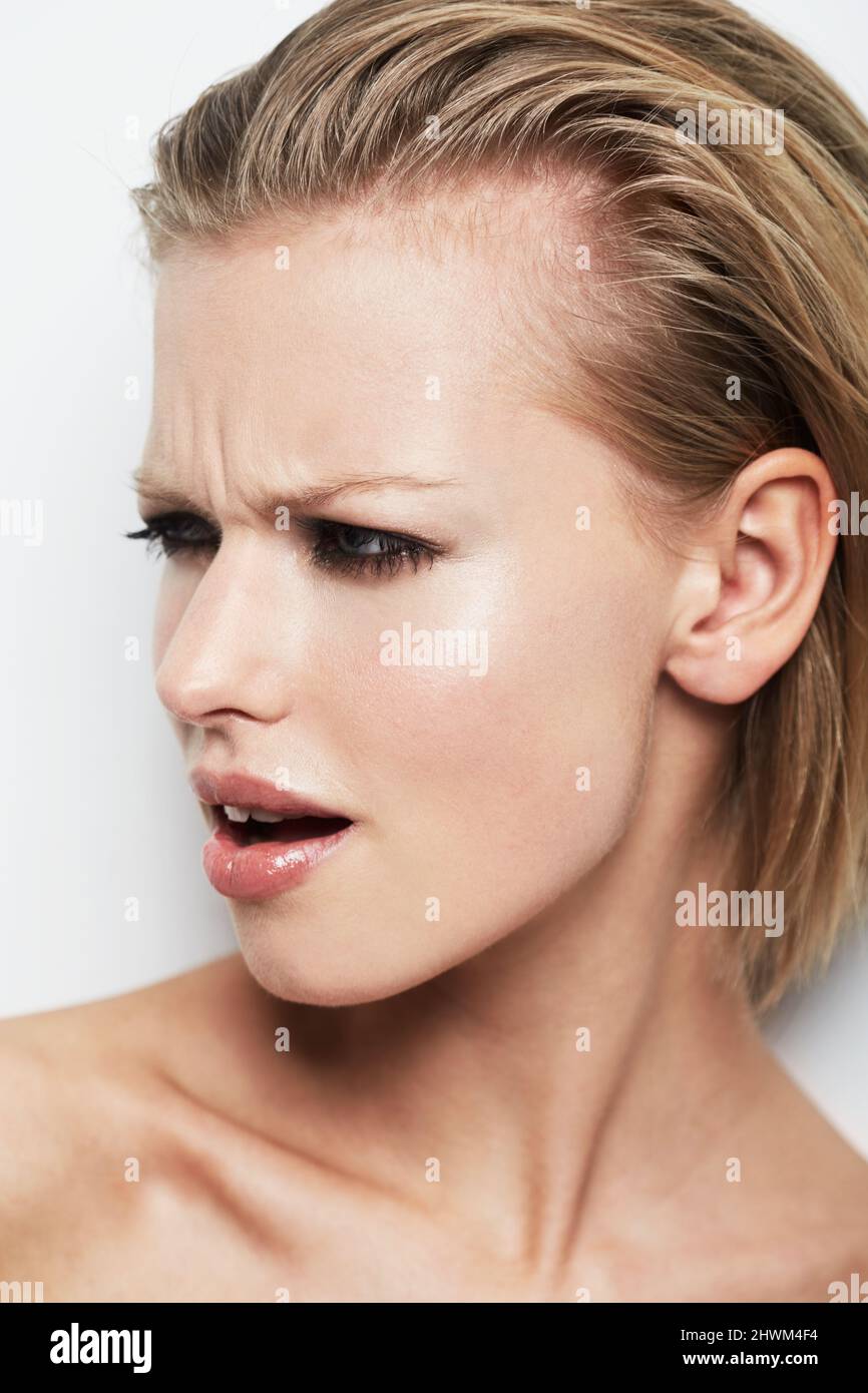 What did you say. An young woman looking at something with offense ...