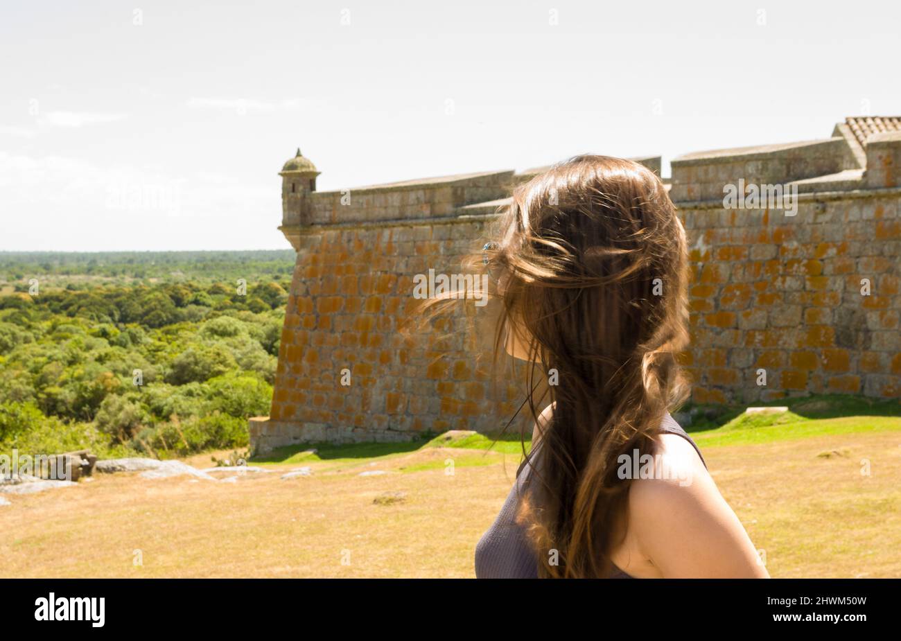 Young woman looking at Forte de Santa Tereza in Uruguay, important ...