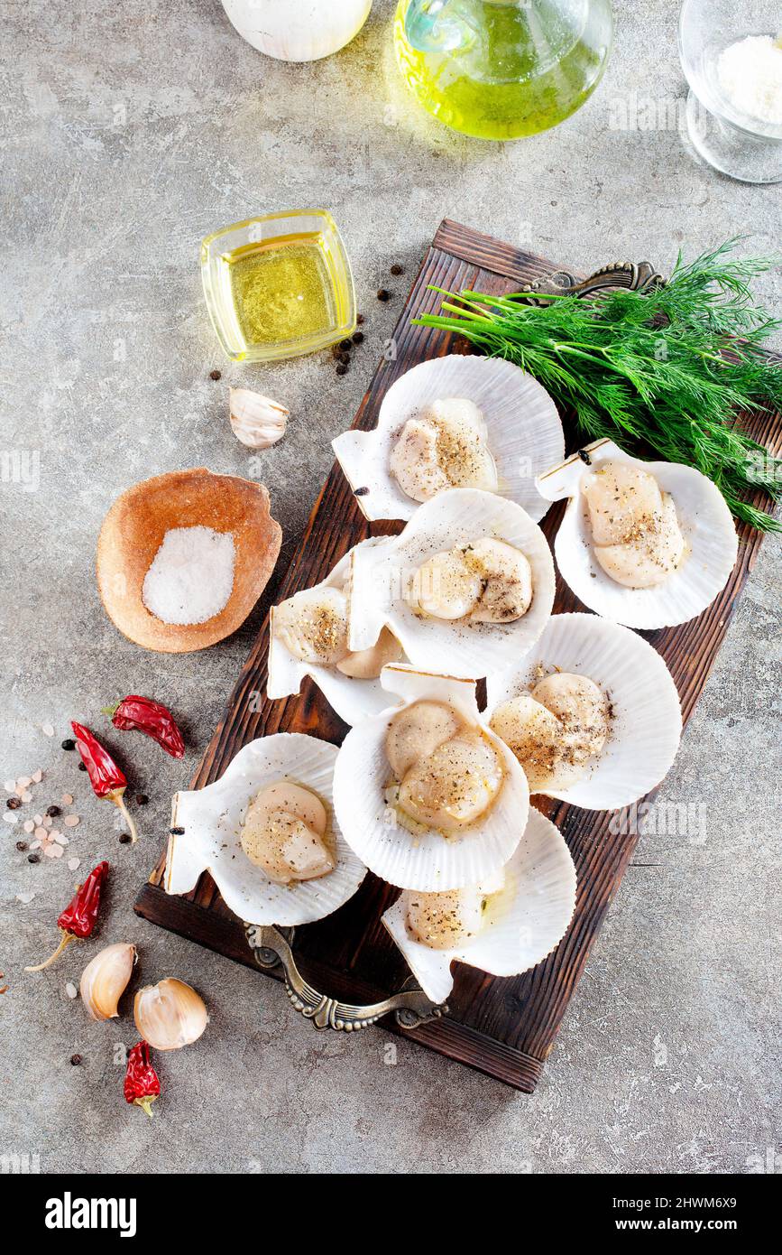 Raw scallops in shells on wooden tray. Mediterranean seafood. Fresh ...