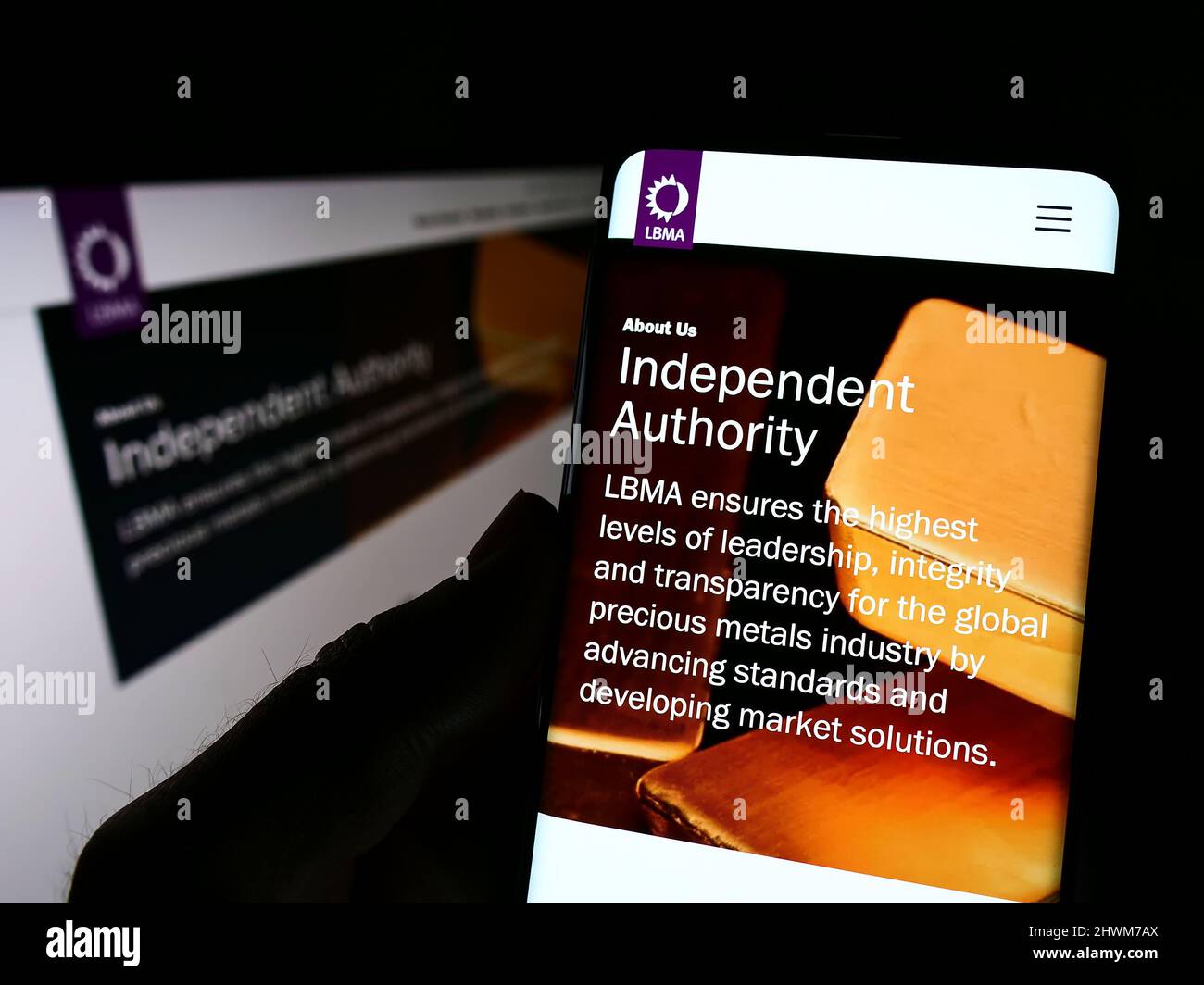 Person holding cellphone with webpage of British London Bullion Market ...