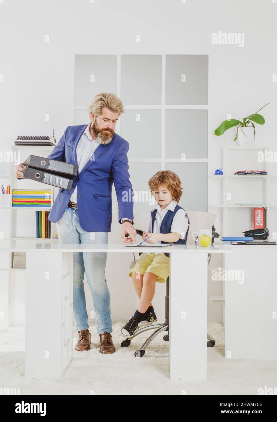 Family business. Father and son in office Stock Photo - Alamy