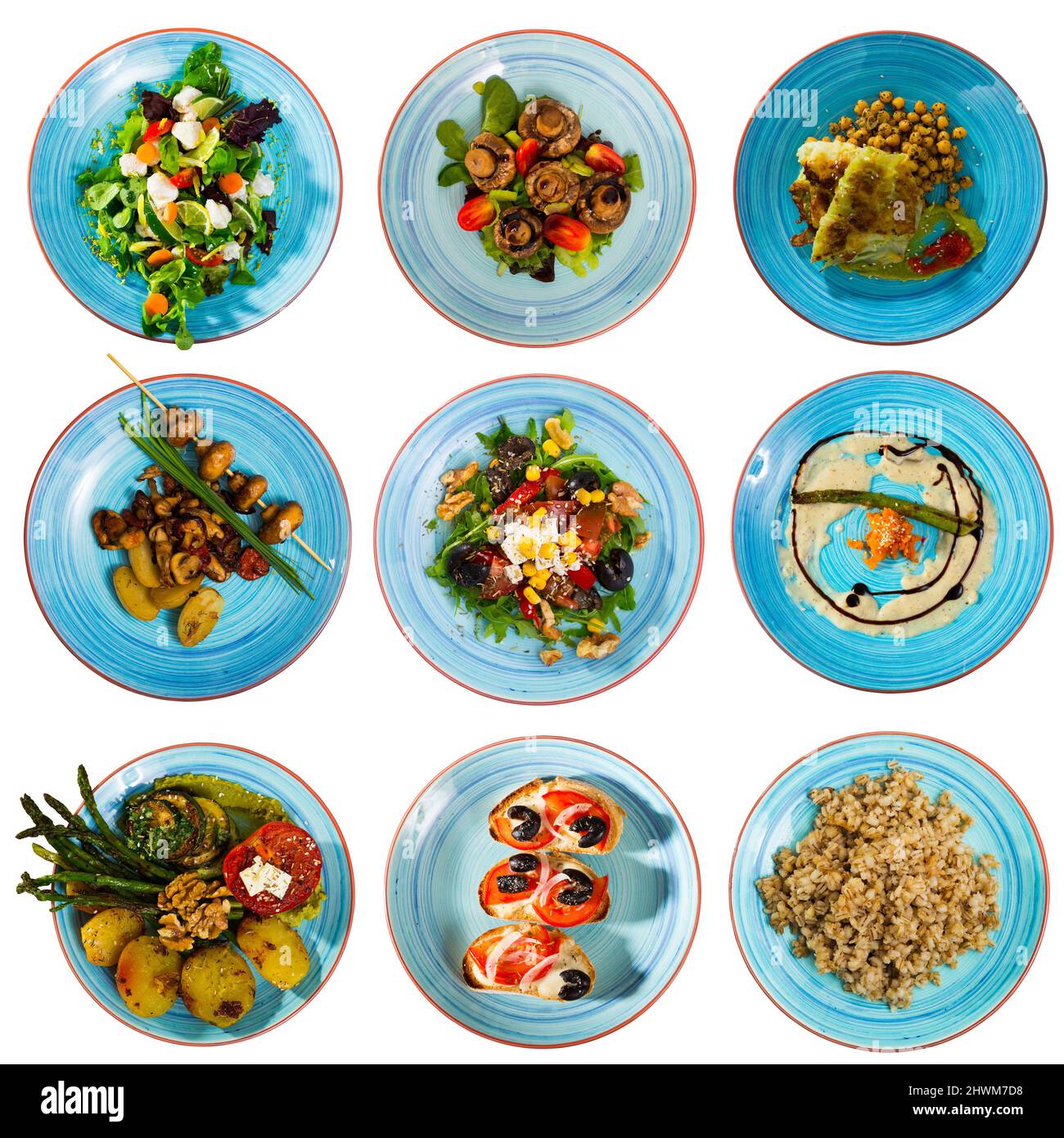 Many plates with different vegetarian food isolated on white background ...