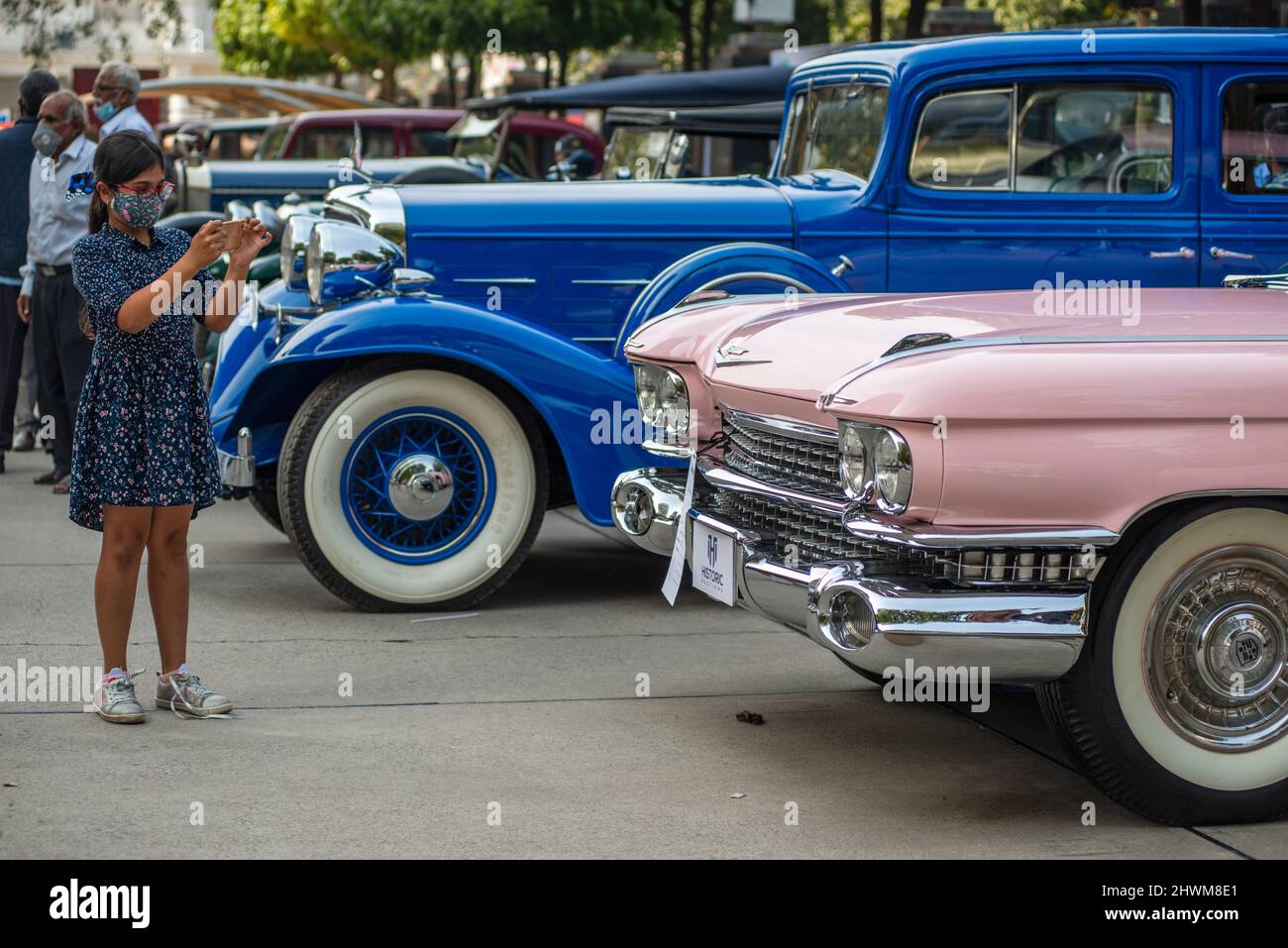 A girl takes photos of vintage cars during The Statesman and VCCI ...