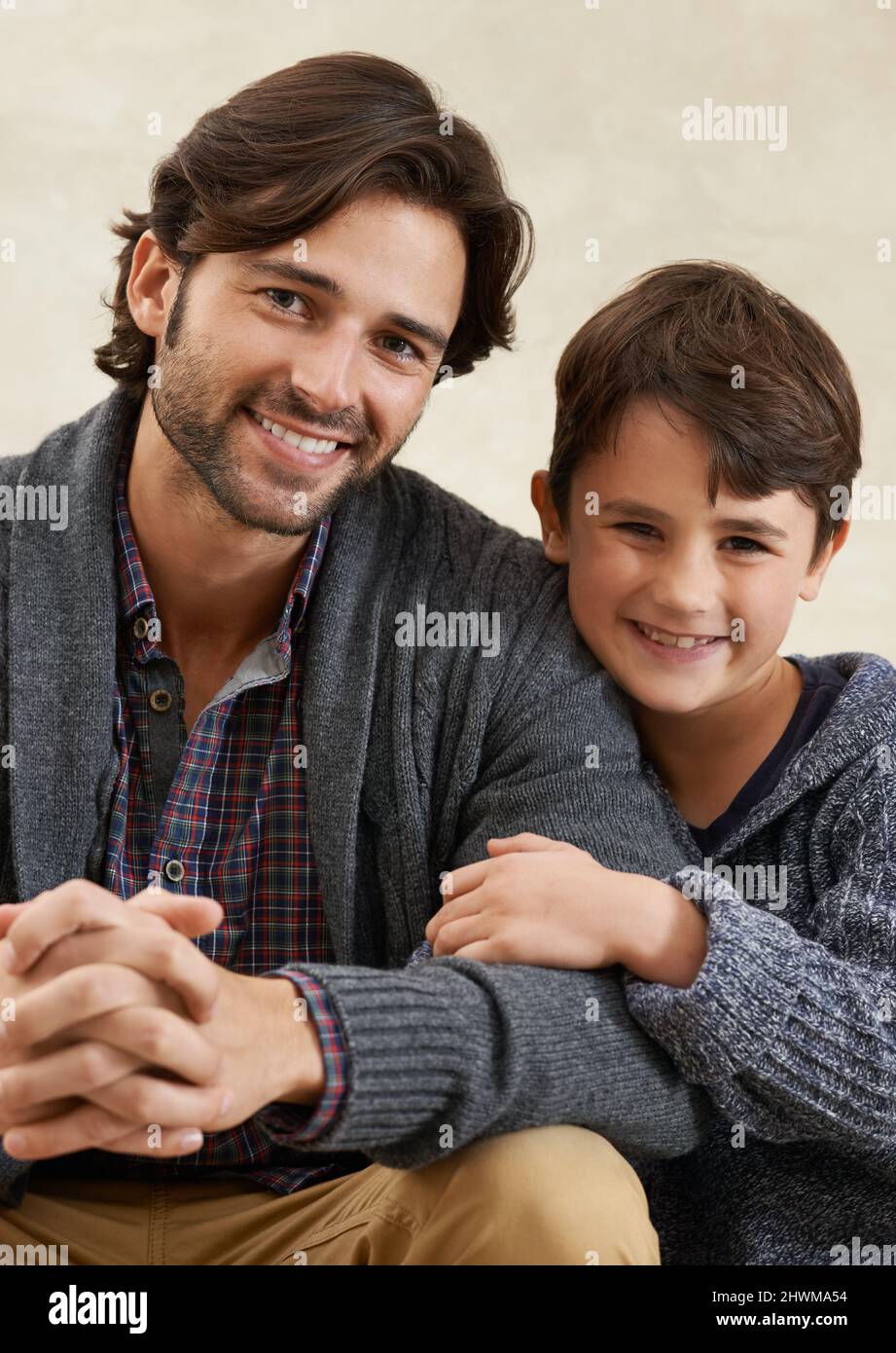 Quality time together. Portrait of a young father and son sitting on ...