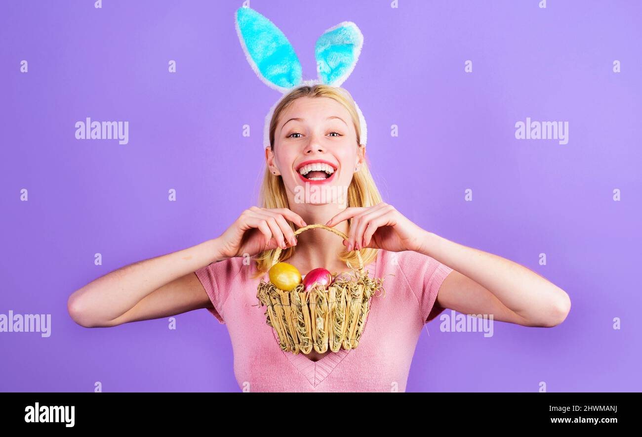 Easter Day Smiling Girl In Rabbit Ears With Basket Of Colored Eggs
