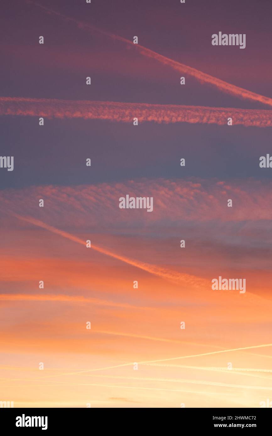Beautiful dusk sky of multiple colours enhanced by aeroplane trails ...
