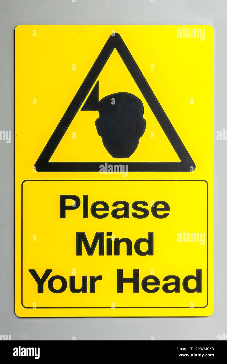 Please mind your head warning sign Stock Photo - Alamy