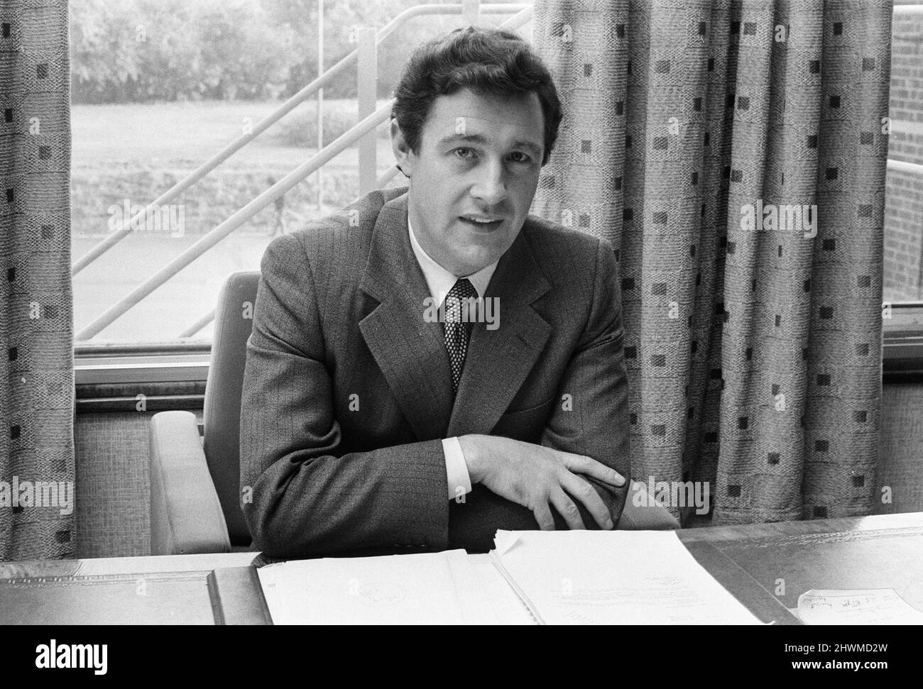 Geoffrey Robinson, Managing Director Jaguar Cars, pictured at his desk ...