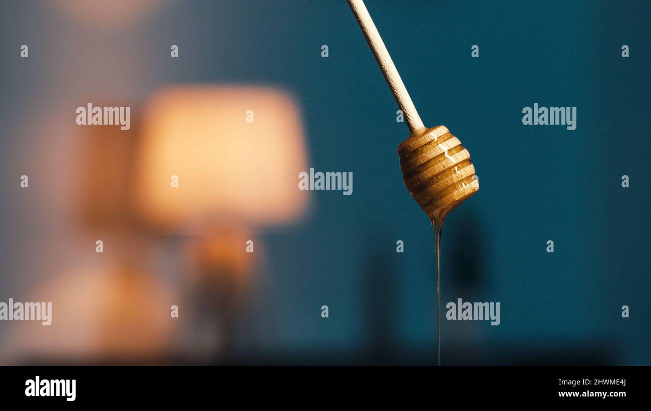 Close up of Dripping Spoon Of Honey Stock Photo - Alamy