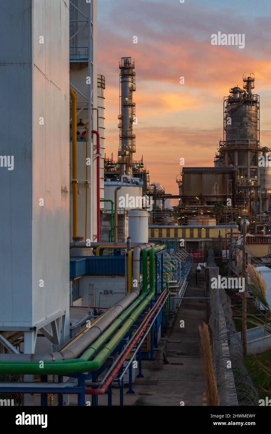 Pipelines in an oil refinery at sunset Stock Photo - Alamy